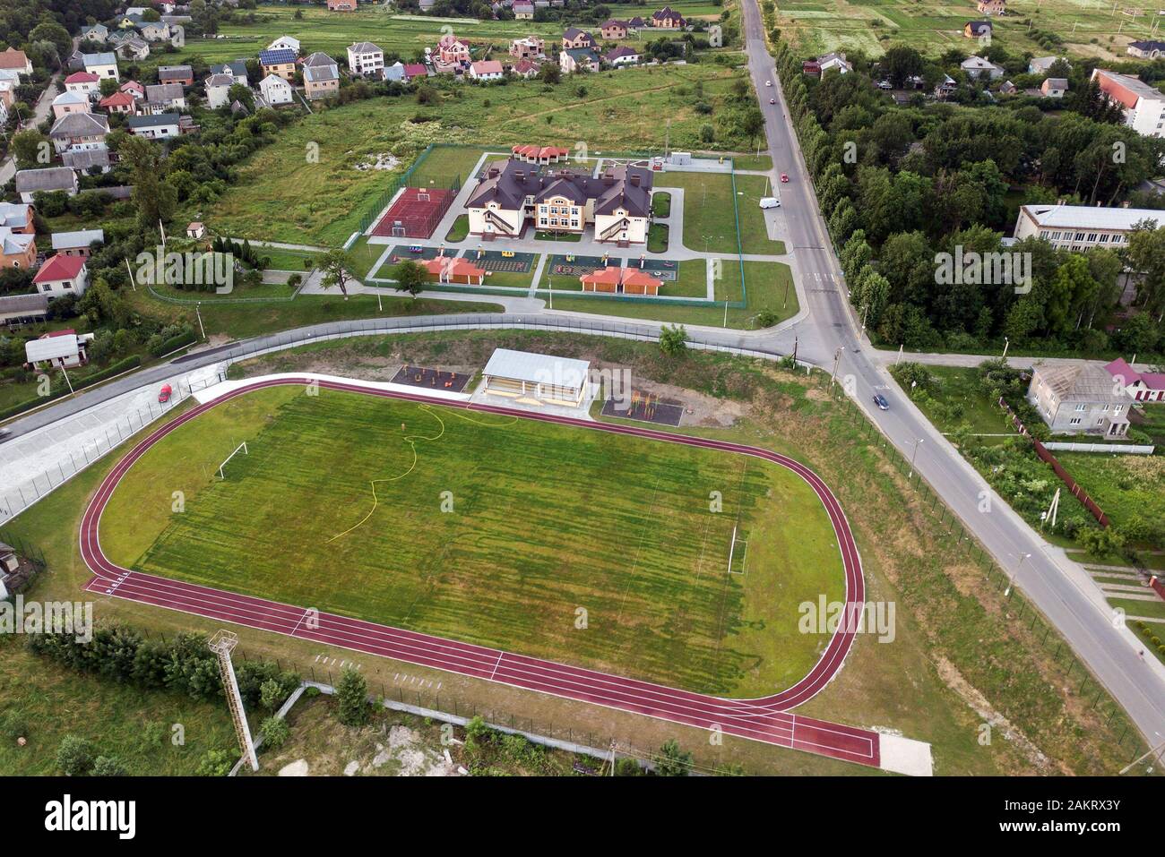 Aerial view of a football field on a stadium covered with green grass ...
