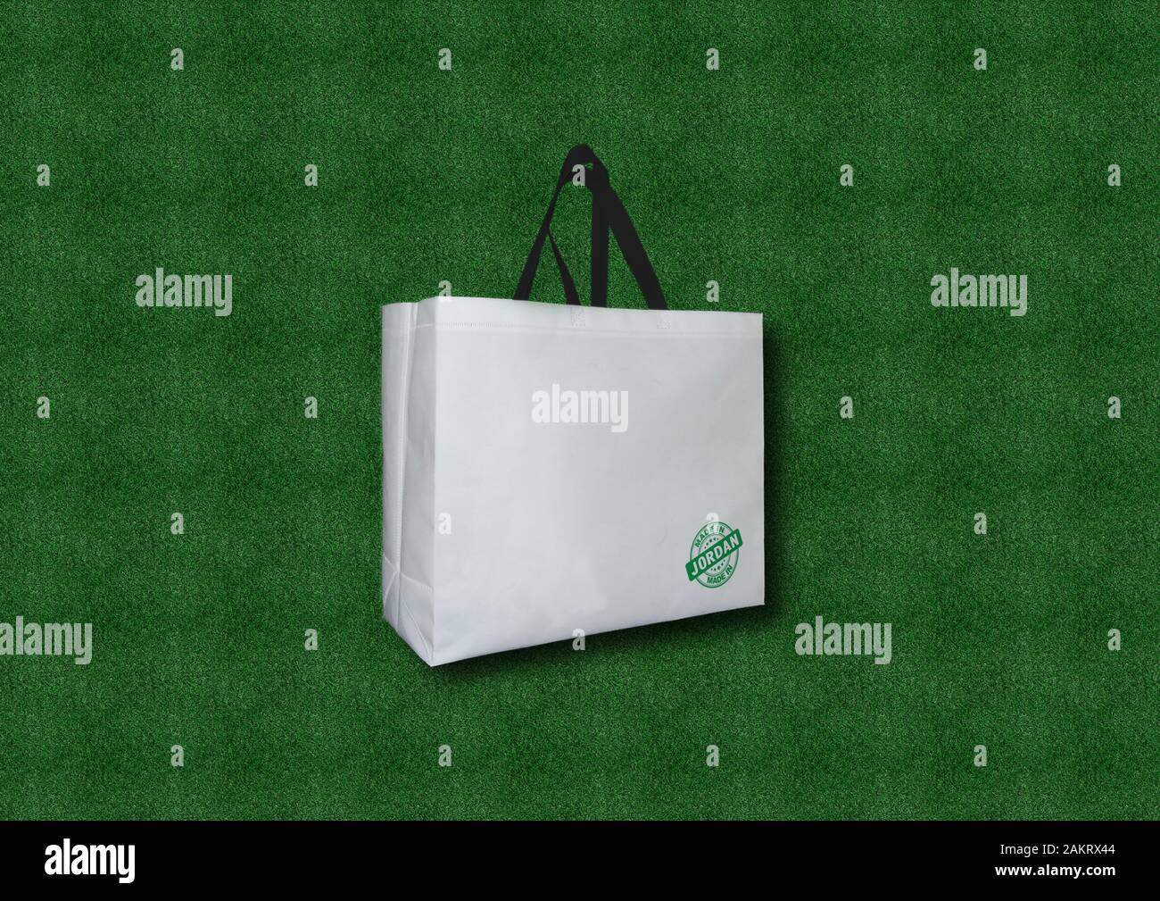 White fabric cloth Recyclable ECO Bag on Green Grass background ...
