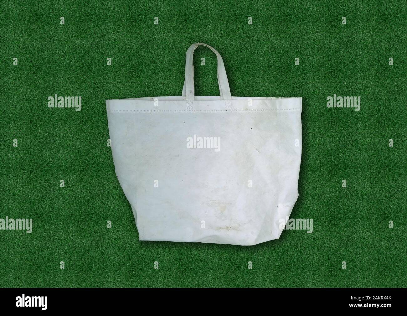 White fabric cloth Recyclable ECO Bag on Green Grass background ...