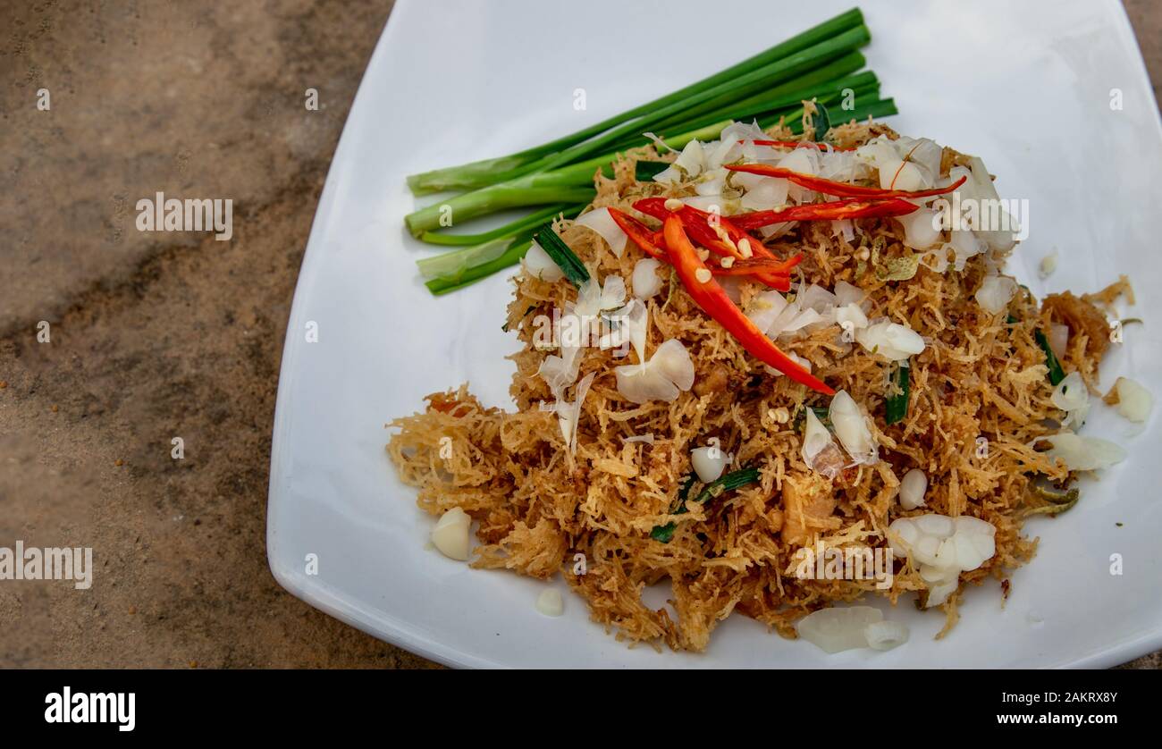 Asian eating food, Mee Grob is an sweet and sour crispy noodles, made ...