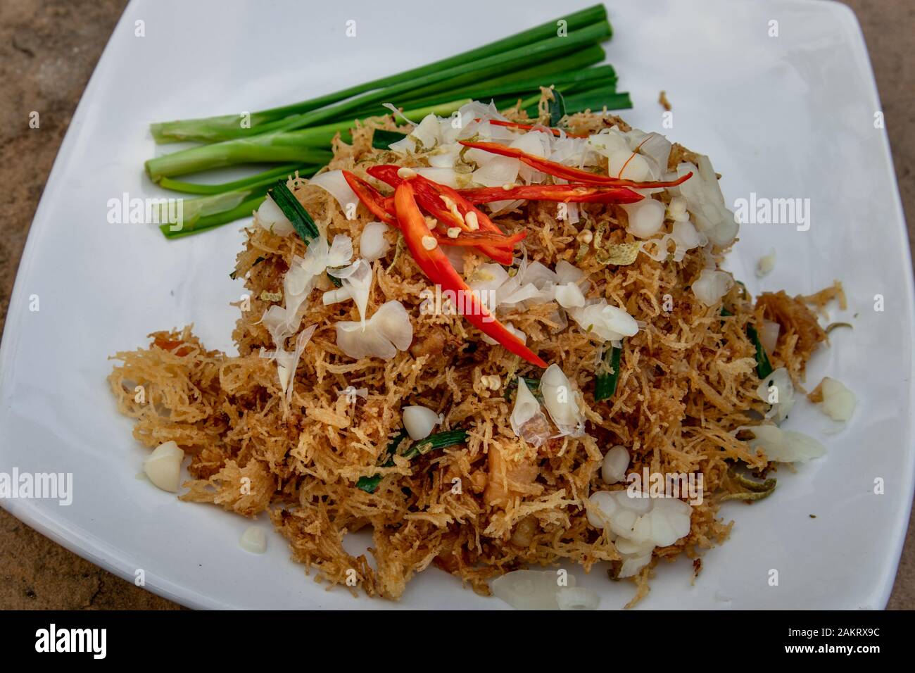 Asian eating food, Mee Grob is an sweet and sour crispy noodles, made ...