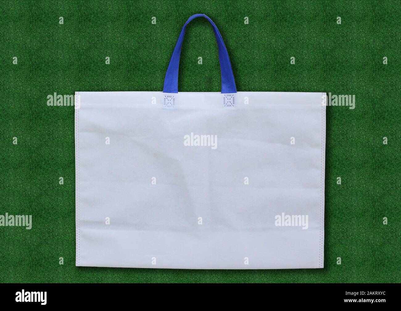 White fabric cloth Recyclable ECO Bag on Green Grass background ...
