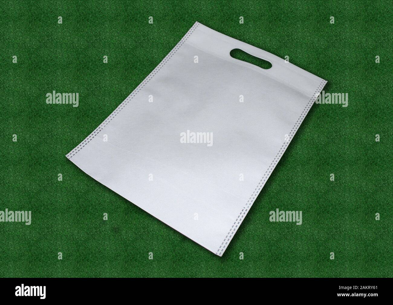 White fabric cloth Recyclable ECO Bag on Green Grass background ...