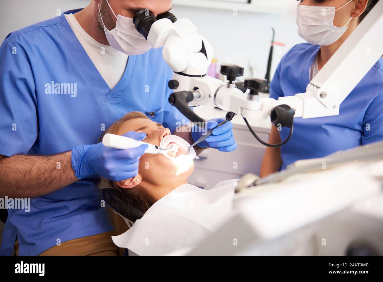 Dentist using dental microscope and examining woman's teeth Stock Photo ...