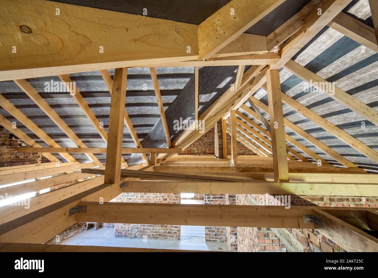 Attic of a building under construction with wooden beams of a roof ...