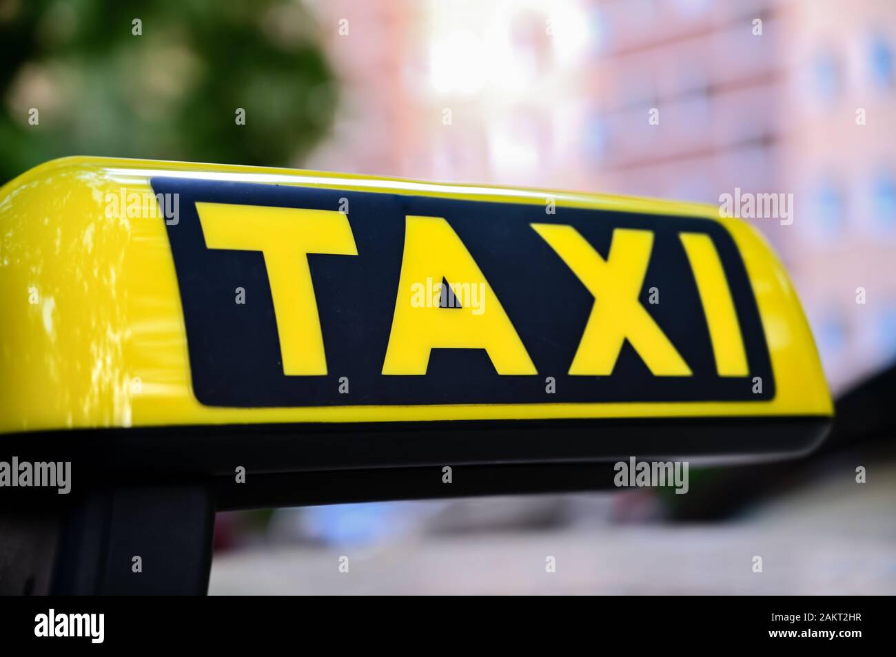 Sign with the lettering Taxi on a car roof with a blurred background ...