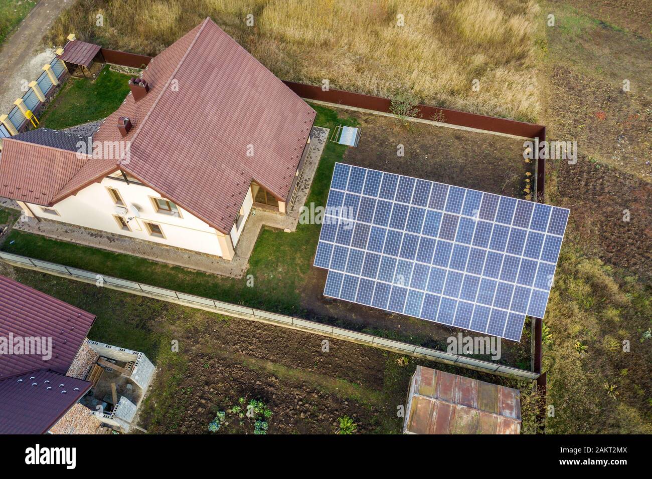 Aerial view of big blue solar panel installed on ground structure near ...