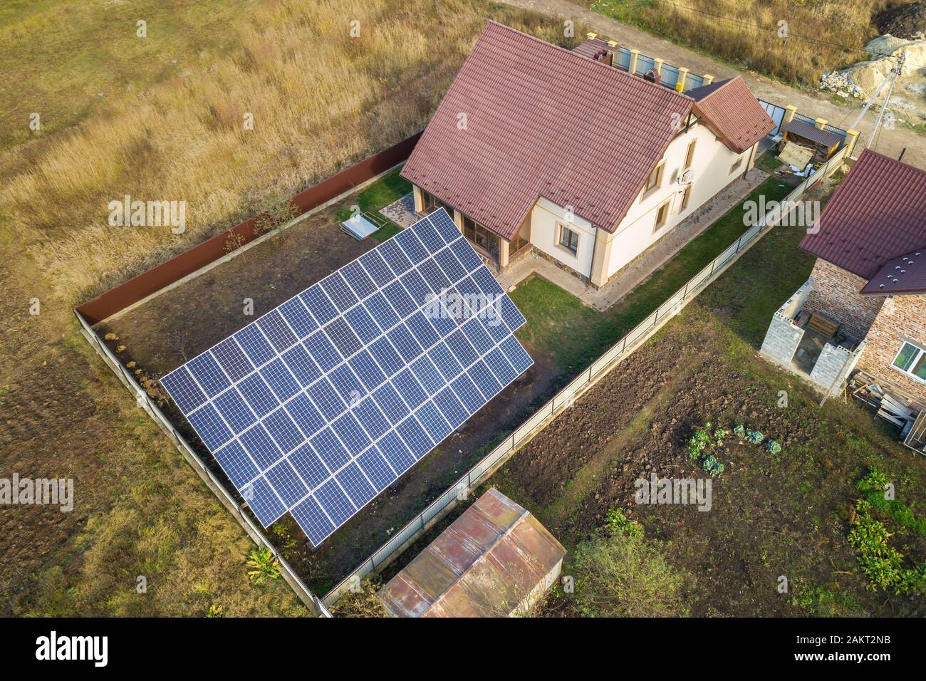 Aerial view of big blue solar panel installed on ground structure near ...