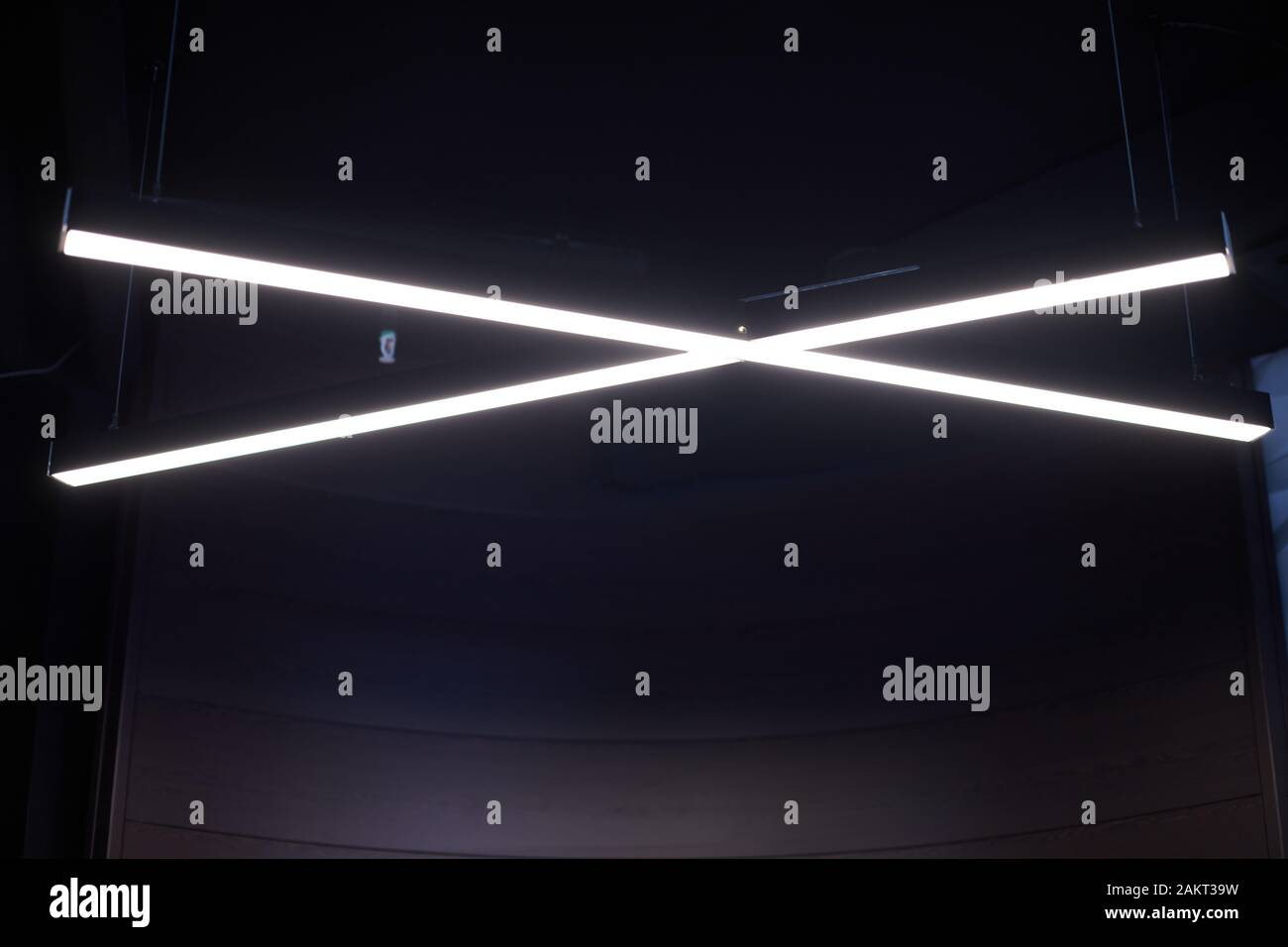 Modern office lighting. Thin lamps in office dark ceiling. LED white ...