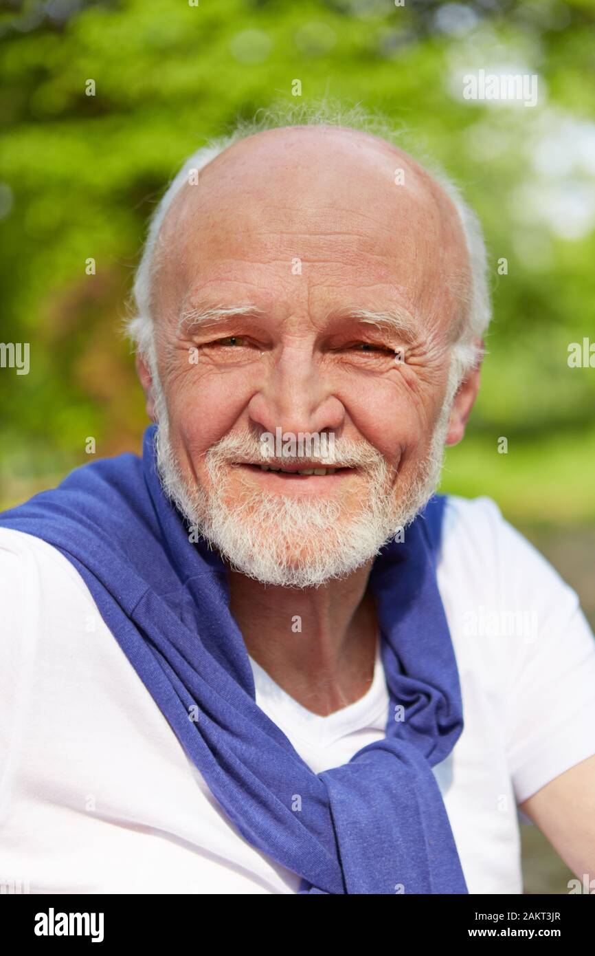 Old man smiles contentedly in nature in summer Stock Photo - Alamy