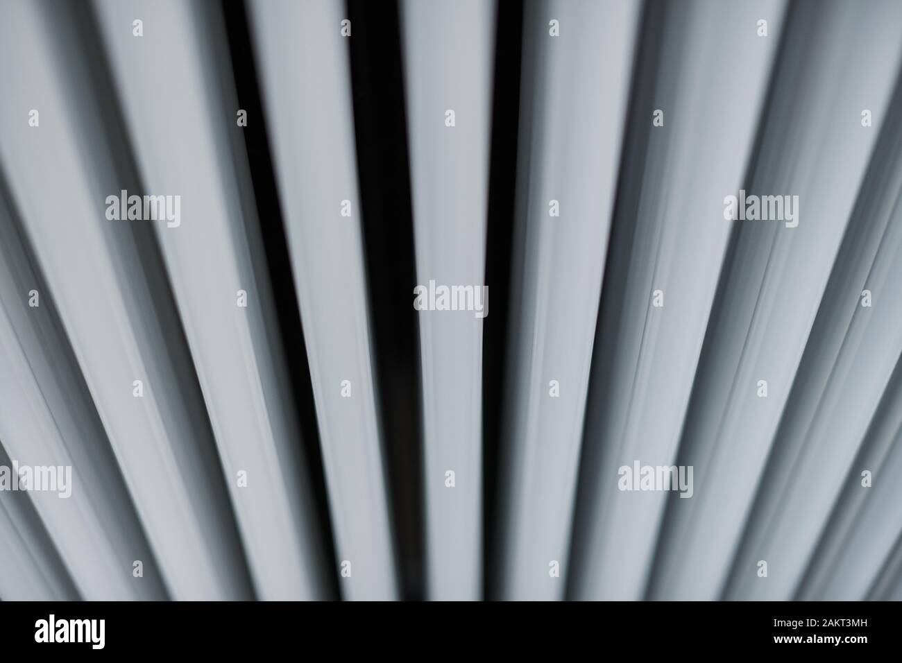 Heating radiator in office, close up. White heat exchangers. Iron ...