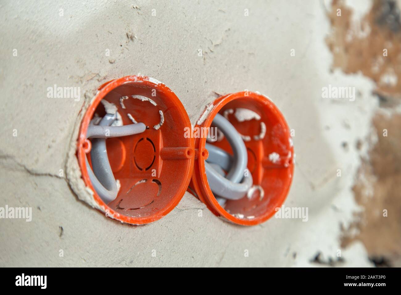 Socket orange boxes with wires in a wall. Cabling installation of ...