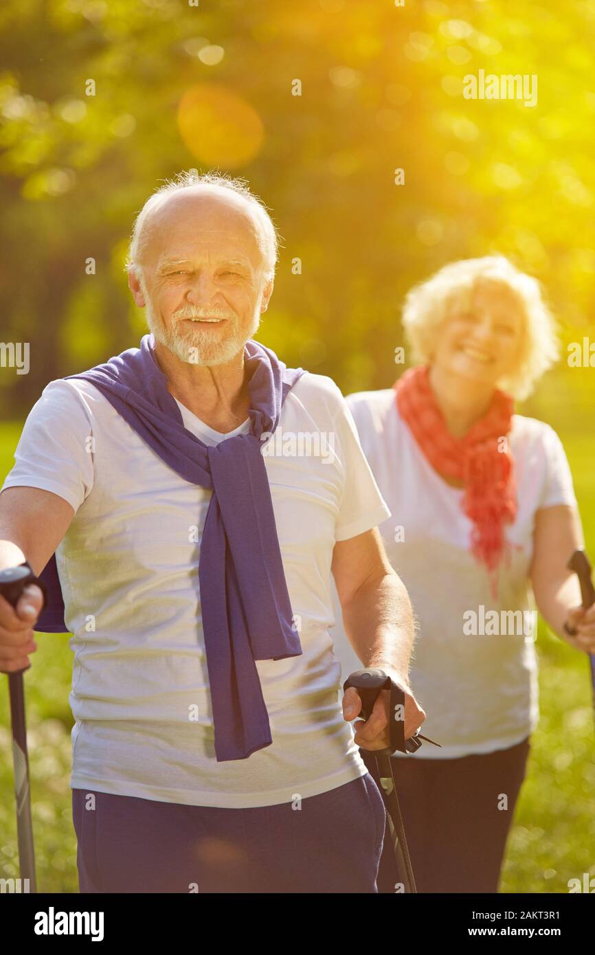 Two seniors walk together in the summer in nature Stock Photo - Alamy