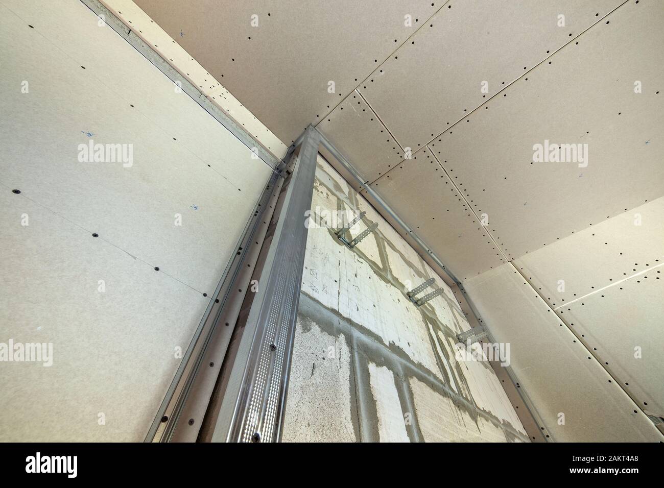 Unfinished brick wall in a room under construction prepared for drywall ...