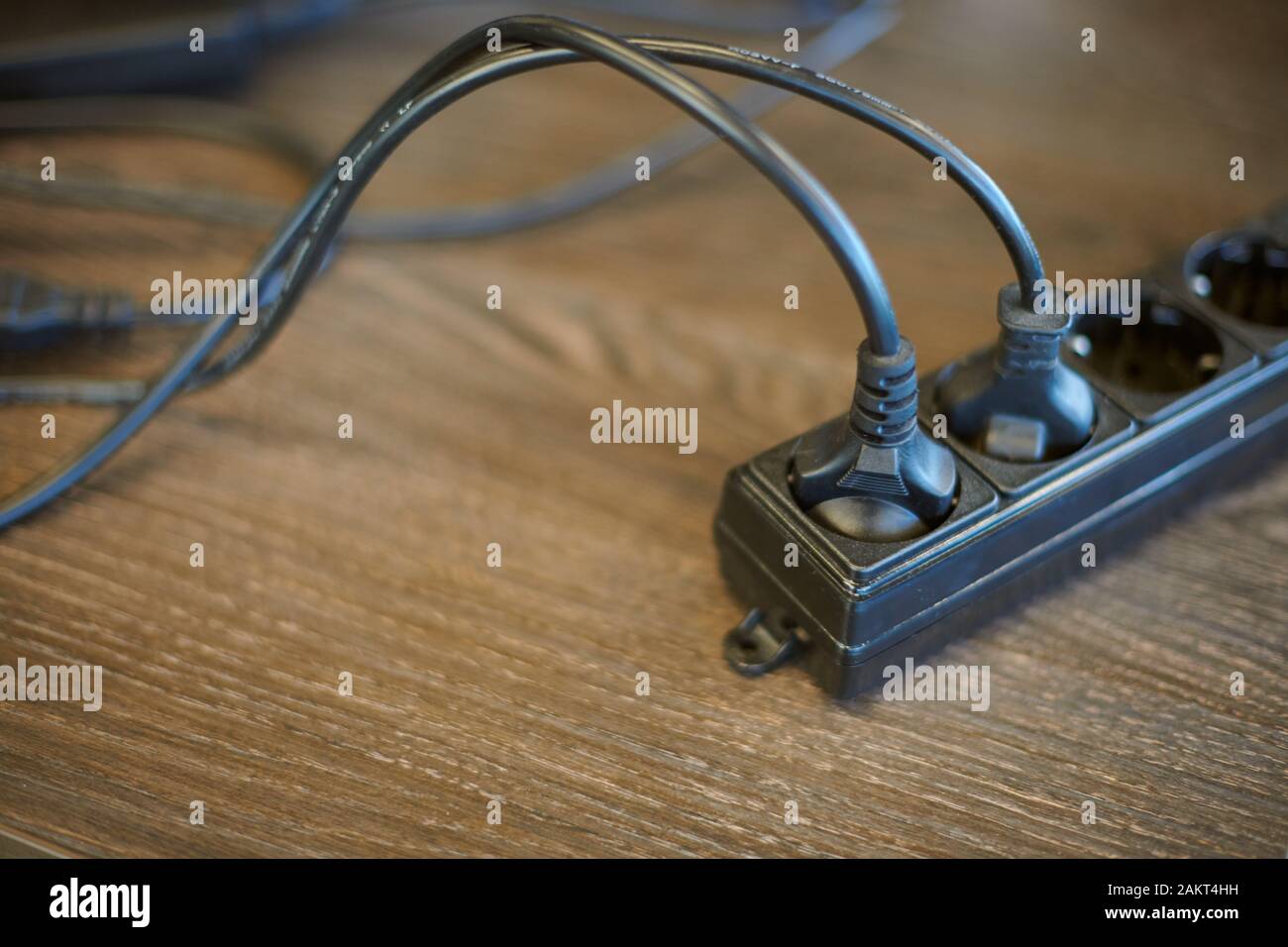 Two plugs plugged into electric power bar. Power supply for computer ...