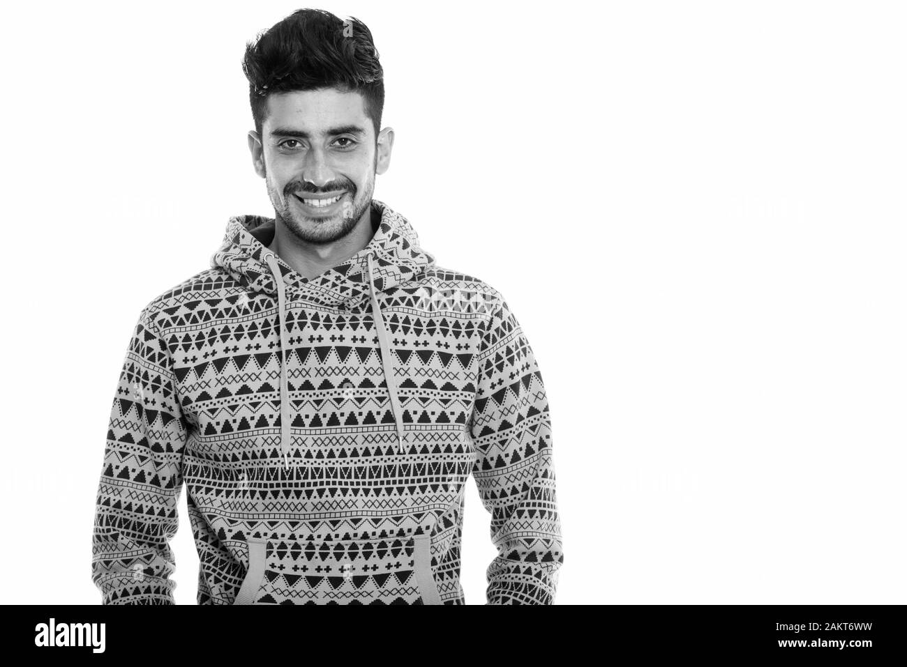 Studio shot of young happy Persian man smiling Stock Photo - Alamy