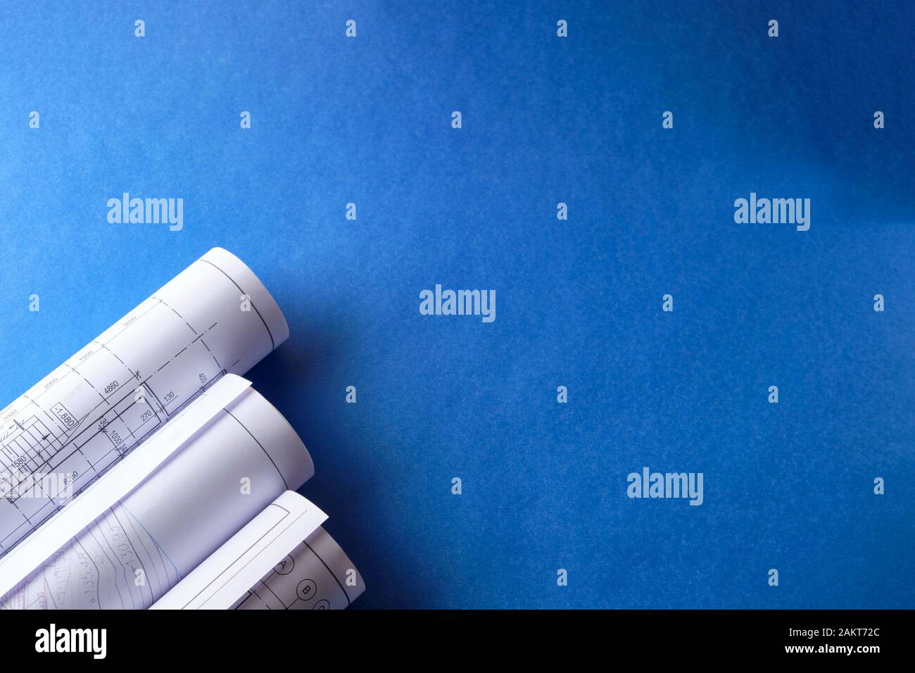 Rolled engineering drawings at blue background with copy space Stock ...