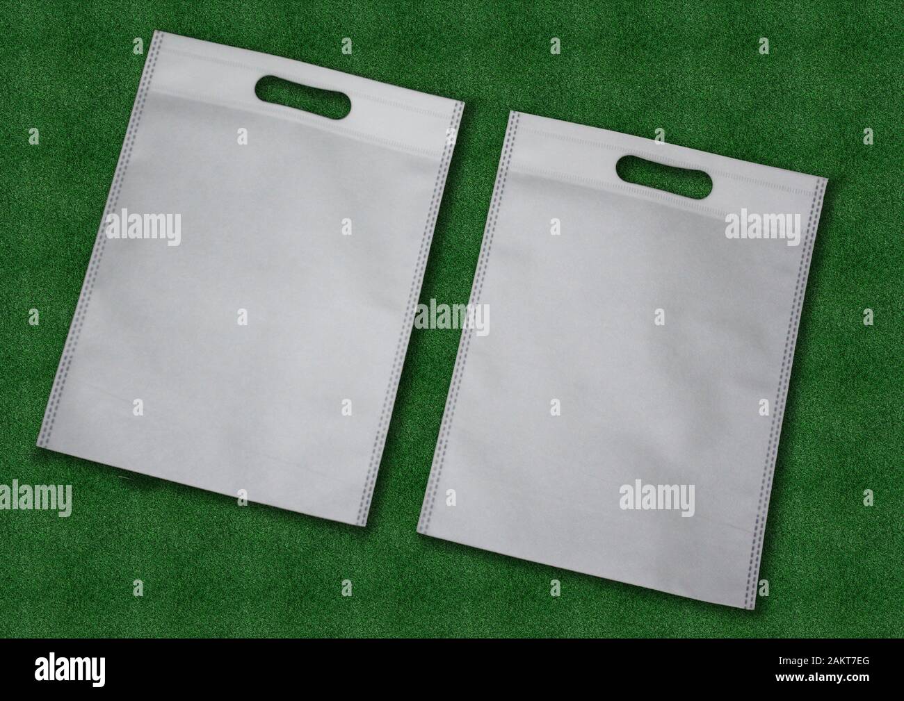 White fabric cloth Recyclable ECO Bag on Green Grass background ...