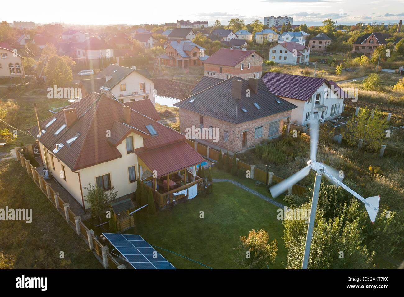 Aerial view of a residential private house with solar panels on roof ...
