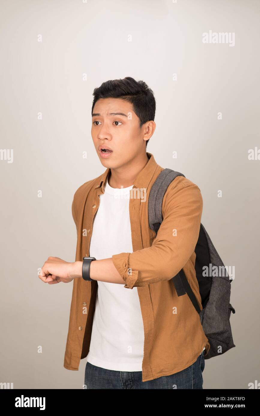 Asian student watching the clock isolated on white background Stock ...