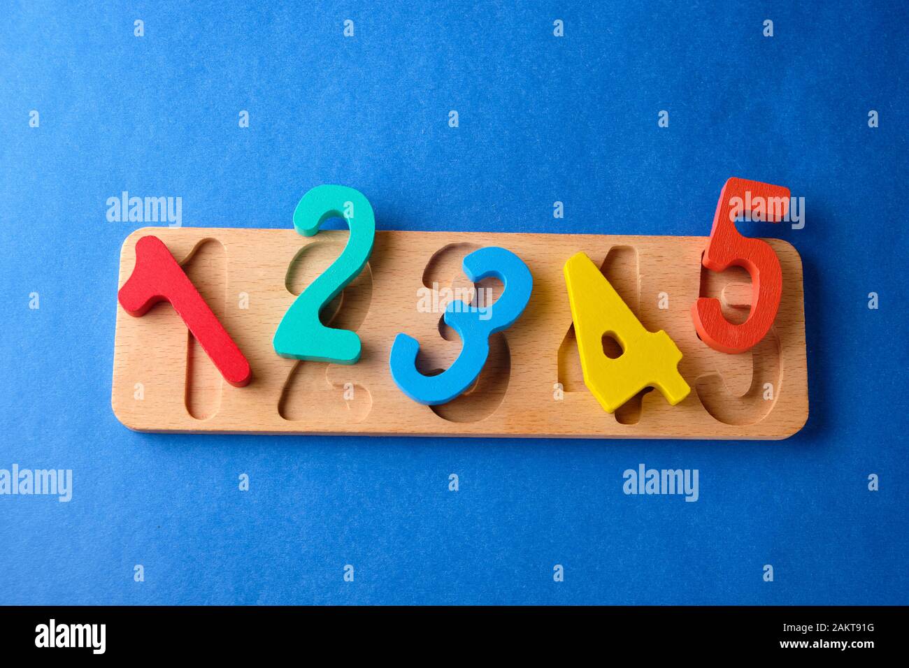 Multi colored toy numbers at blue background with copy space Stock ...