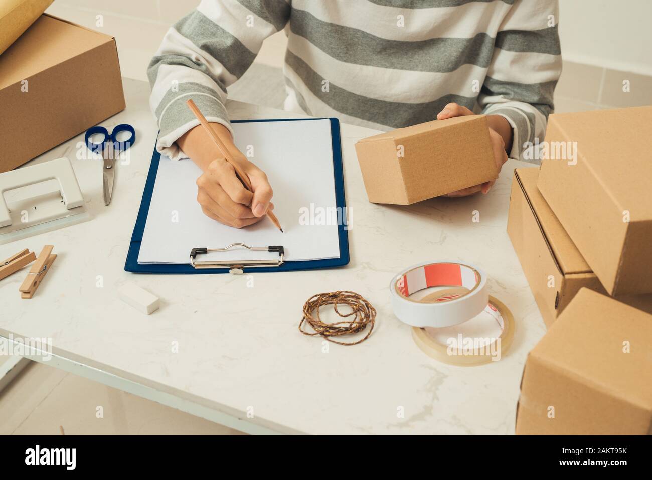Courier holding carton box and delivery receipt Stock Photo - Alamy