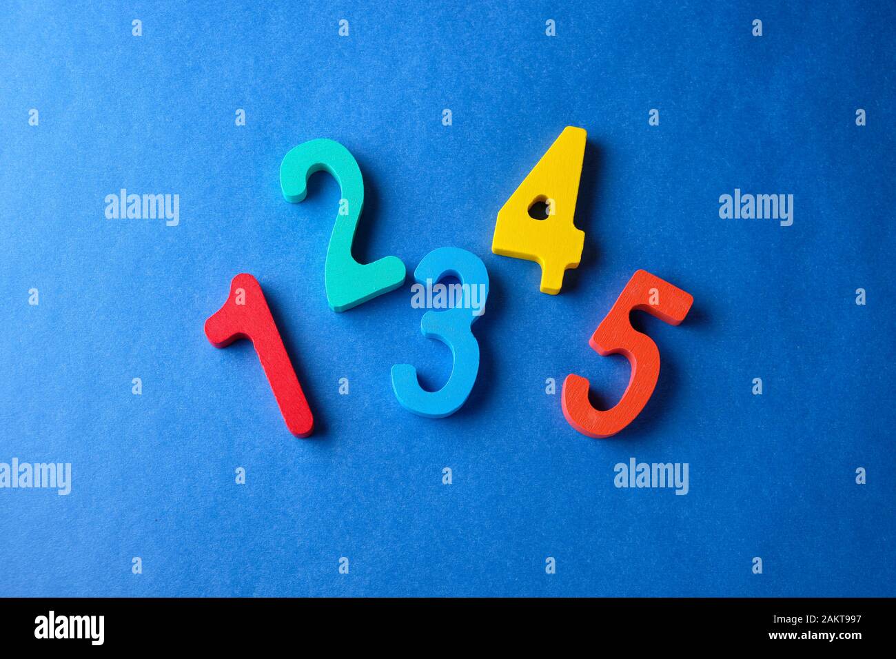 Multi colored toy numbers at blue background with copy space Stock ...