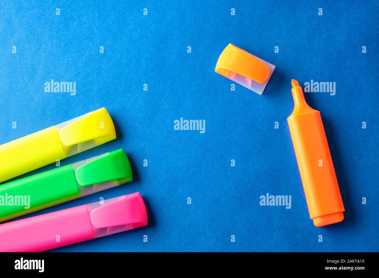 Multi colored highlighters at blue background with copy space Stock ...