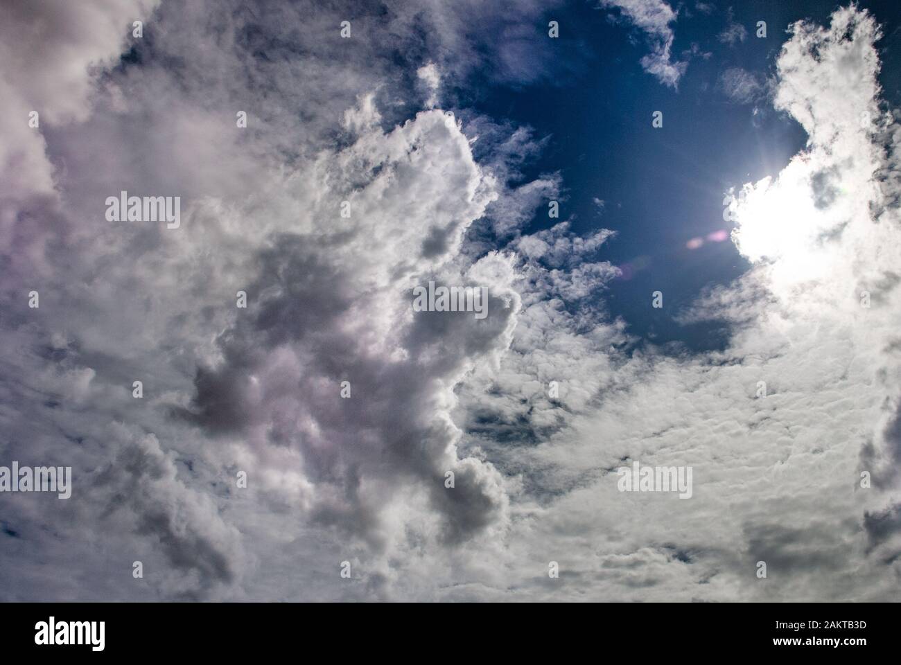Beautiful evening skyscape. Sun's rays shine through hole in black ...