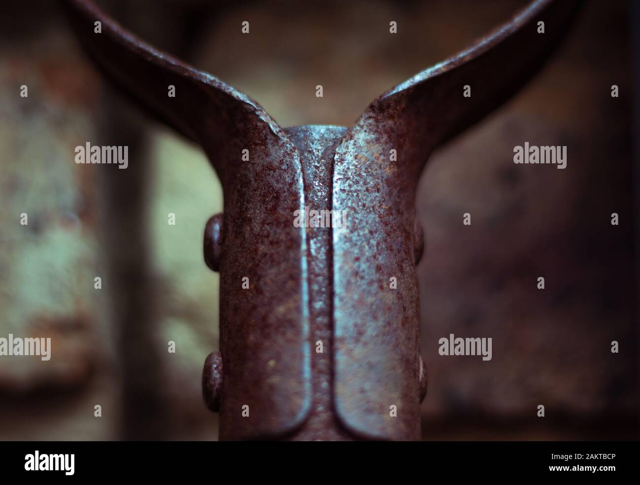 an old rusty garden fork handle with brick background Stock Photo - Alamy