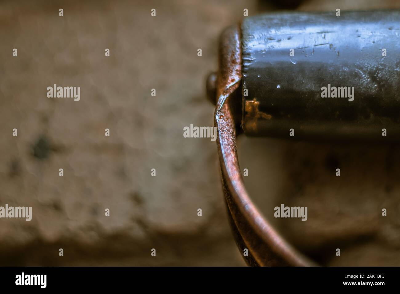 an old rusty garden fork handle with brick background Stock Photo - Alamy