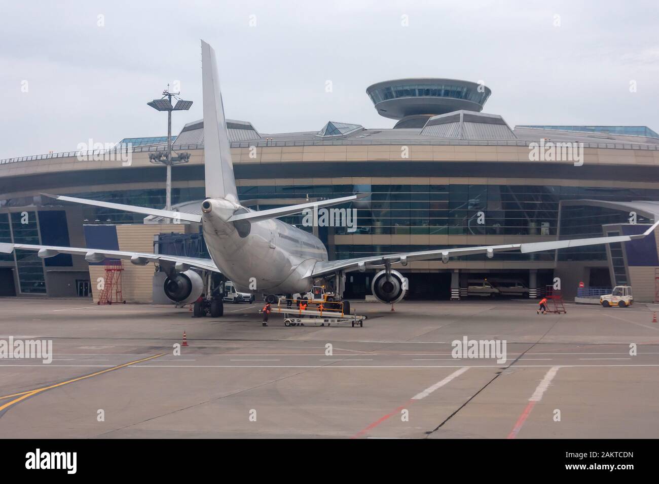 The airport terminal and the atc tower of controllers, airplane nearby ...
