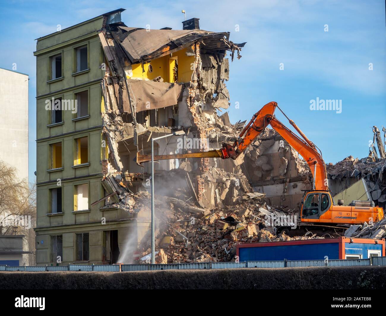 Demolition of an old office building in a traditional way using an ...