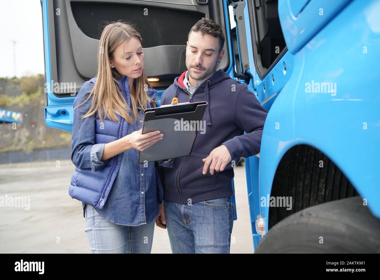 Logistics manager controlling truck driver schedule Stock Photo - Alamy