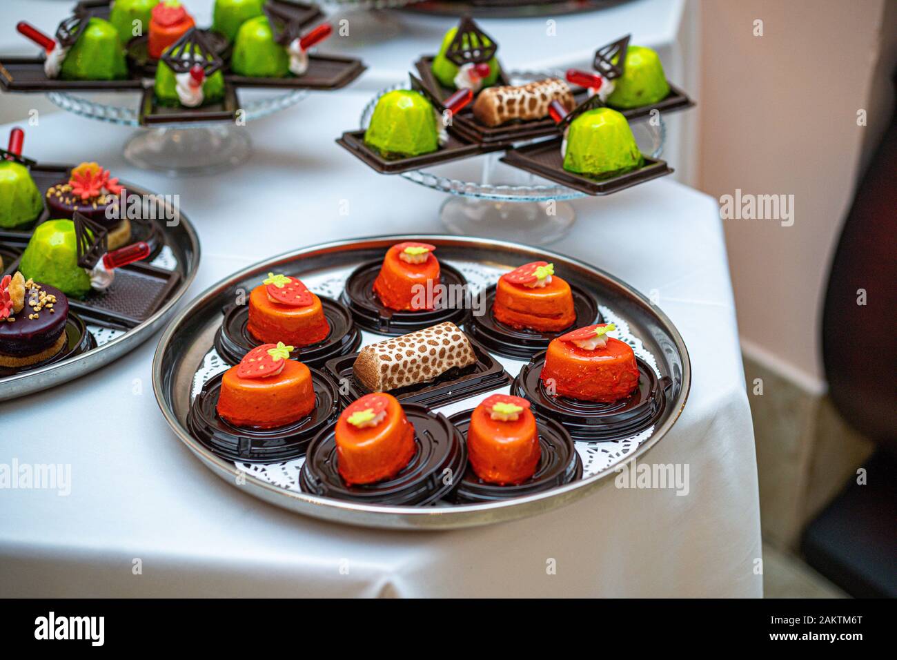 Different sort of beautiful pastry, small colorful sweet cakes Stock ...