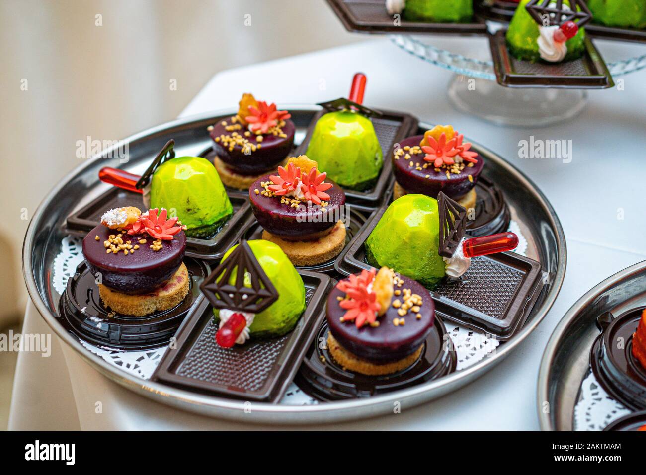 Different sort of beautiful pastry, small colorful sweet cakes Stock ...