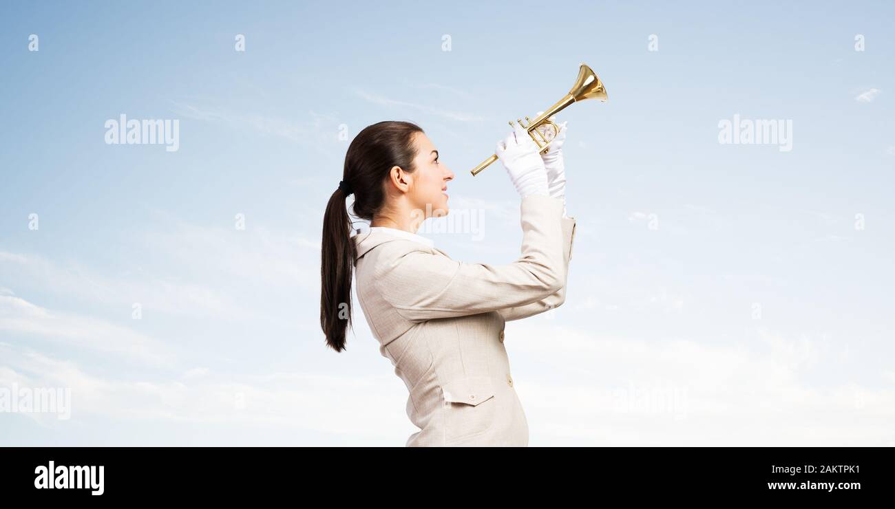 Woman playing trumpet brass instrument Stock Photo - Alamy