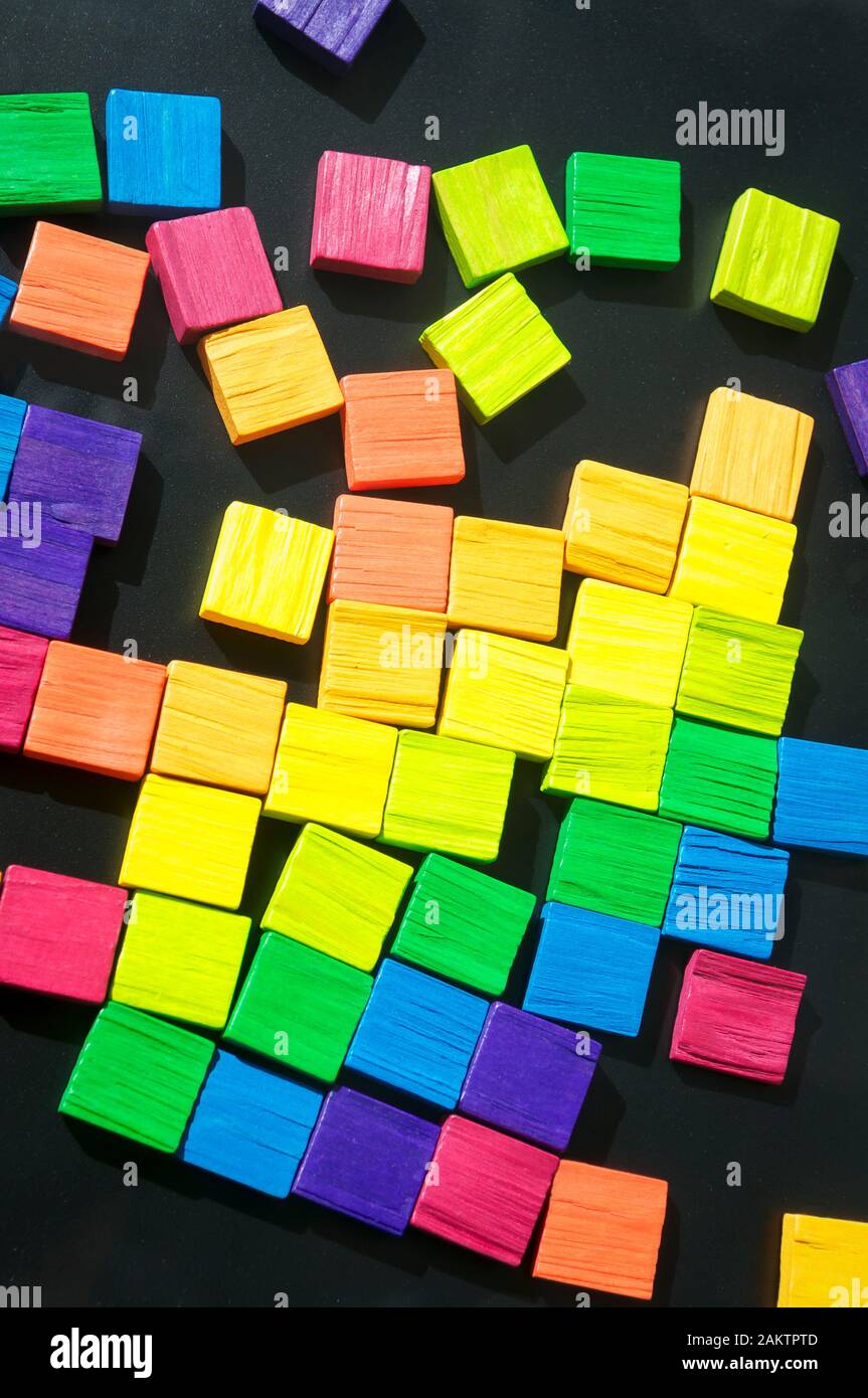 Abstract background of a rainbow of colorful magnetic wooden blocks on ...