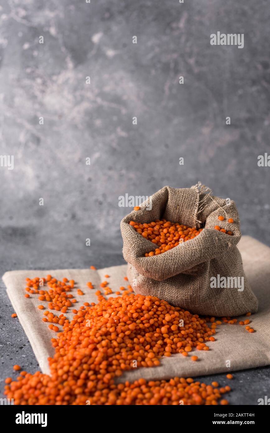 lentils on a gray background red lentils in a wooden spoon and bag ...