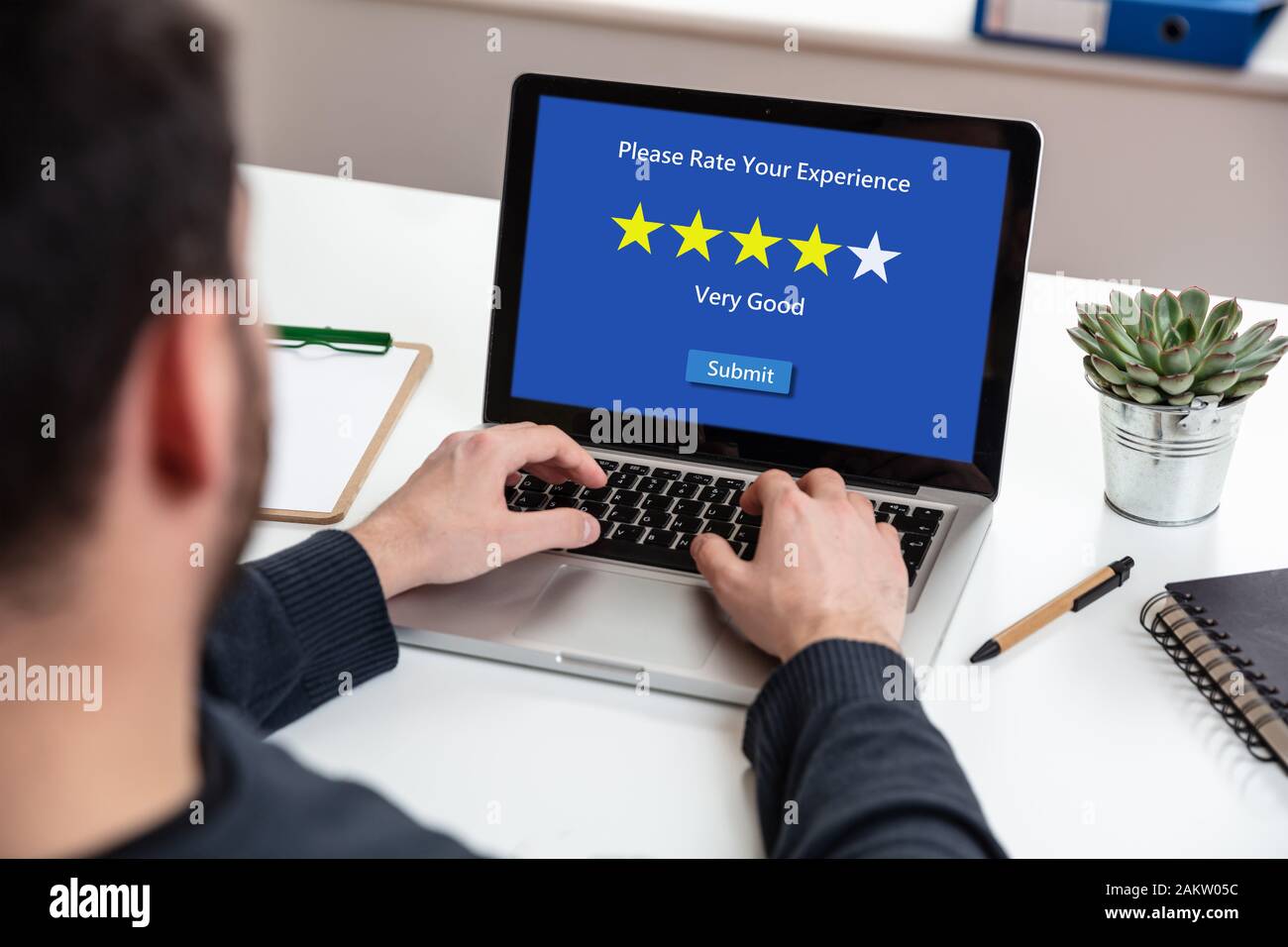 Very good rating review concept. Man working with a computer, 4 stars ...