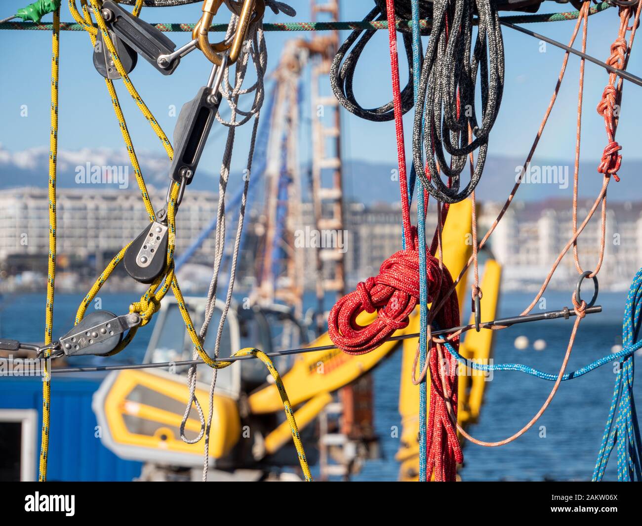 ropes and sailing lines hang down from a boat mast. The multicolored ...