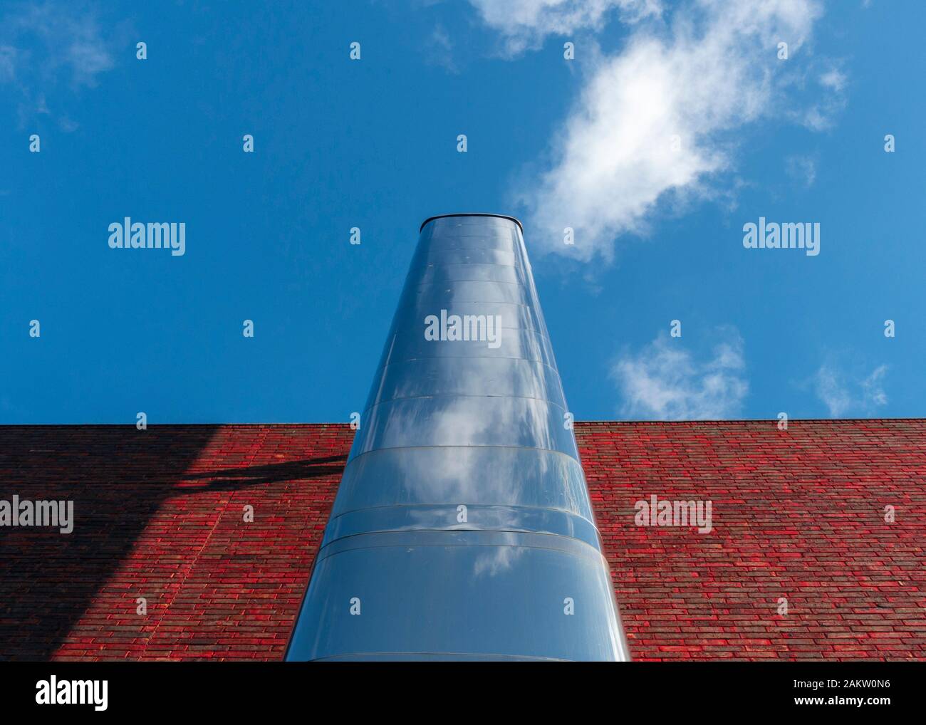 Silver Chimney Under a Blue Sky Stock Photo - Alamy