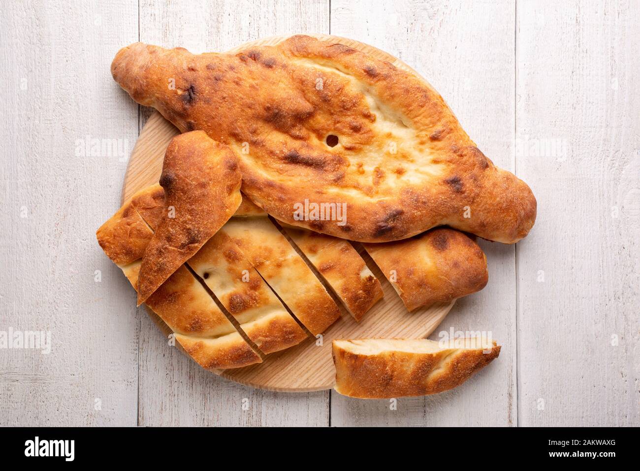 Traditional national Georgian Shoti bread. Whole and sliced bread lies ...