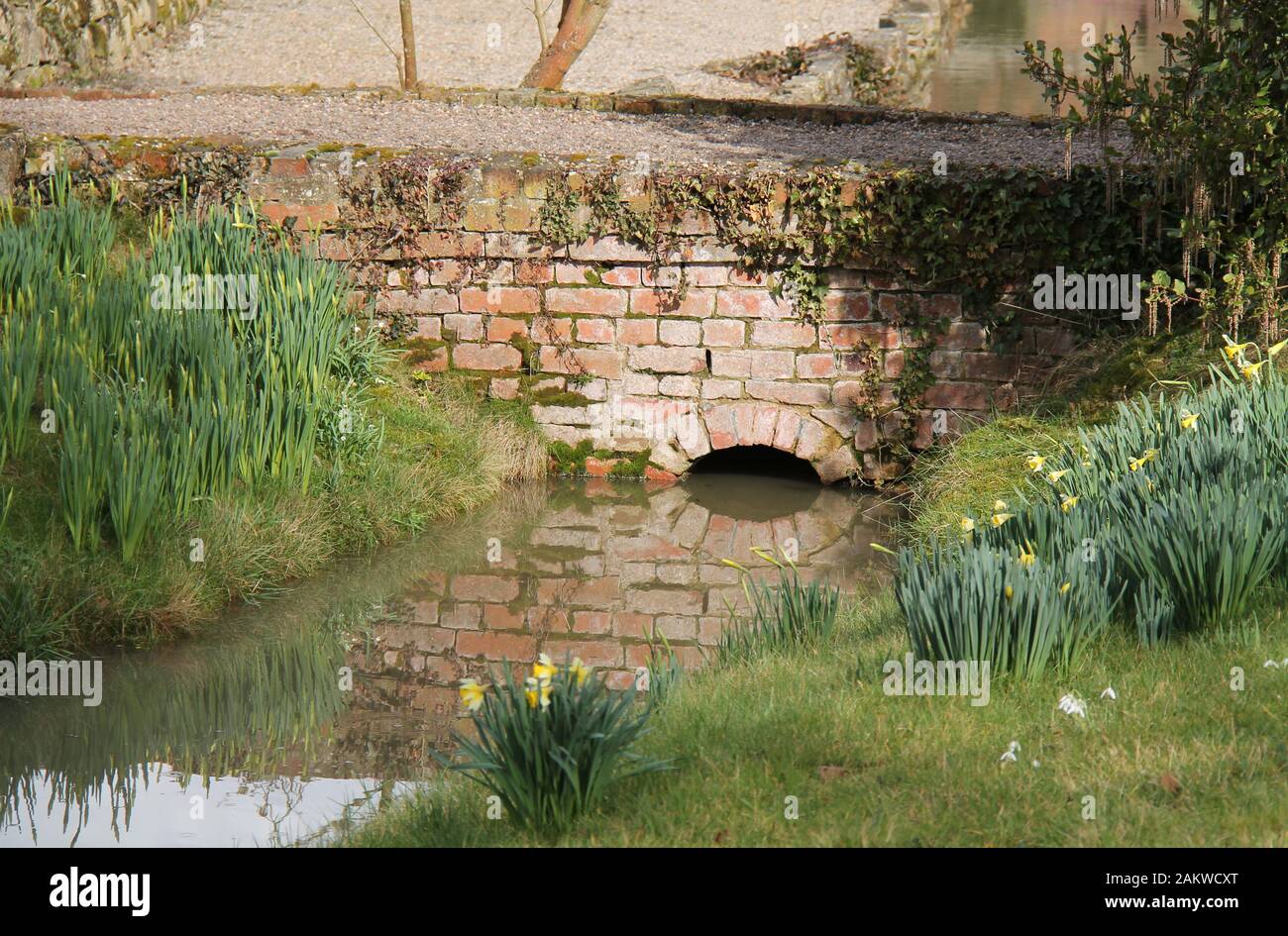A Brick Built Pathway Bridge Over a Small Stream Stock Photo - Alamy