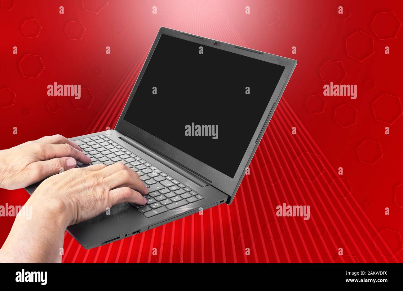 Modern slim laptop on a red background with hands on a keyboard Stock ...