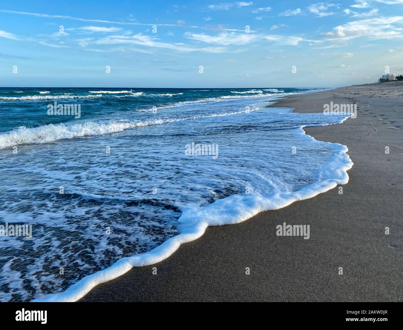 Ocean waves lapping on the beach on a beautiful sunny day along the ...