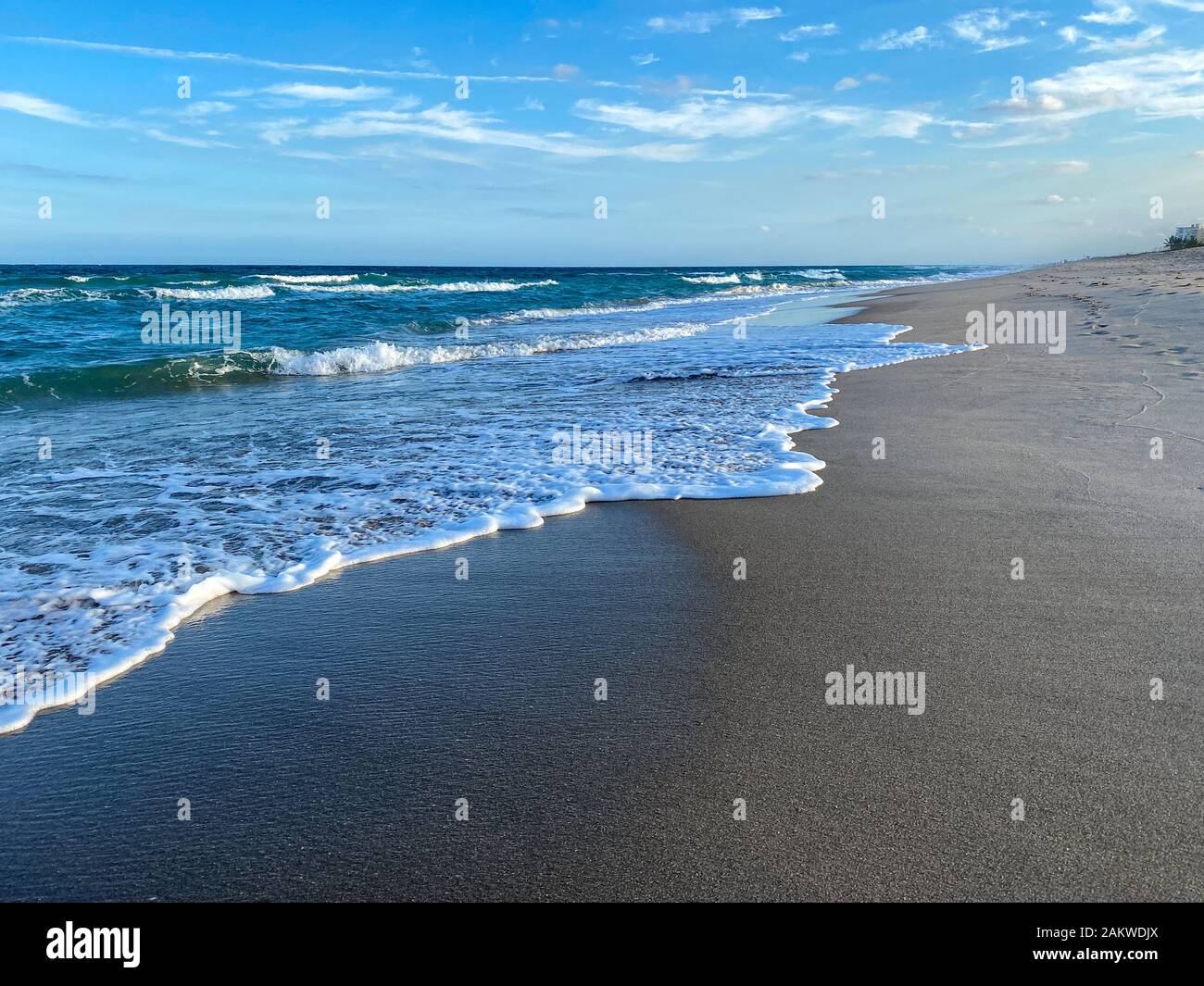 Ocean waves lapping on the beach on a beautiful sunny day along the ...