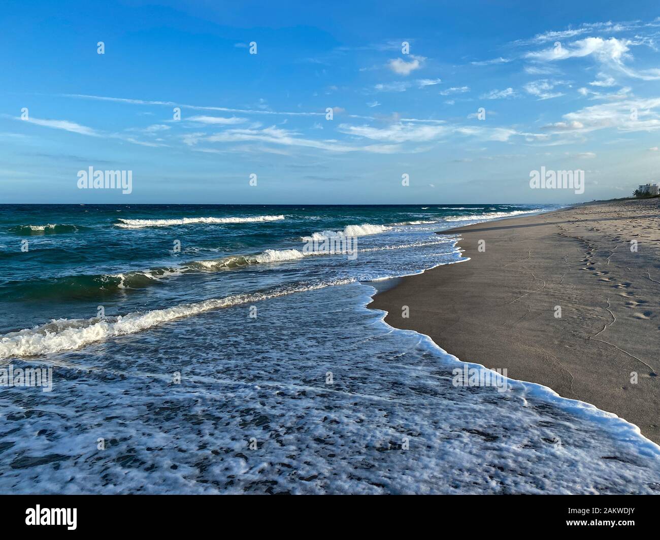 Ocean waves lapping on the beach on a beautiful sunny day along the ...