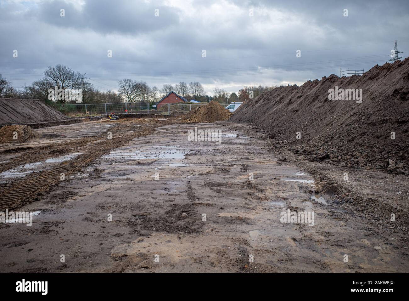 on a large construction site, excavators are used to remove topsoil so ...