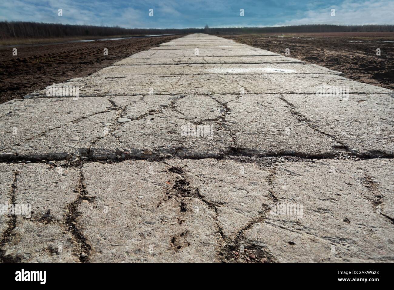 Long cement road on a peat field Stock Photo - Alamy